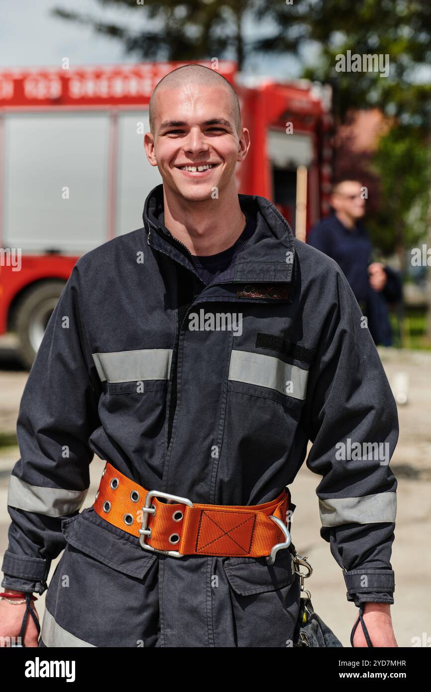 Firefighter Stands Proudly with Professional Gear Beside Fire Truck ...