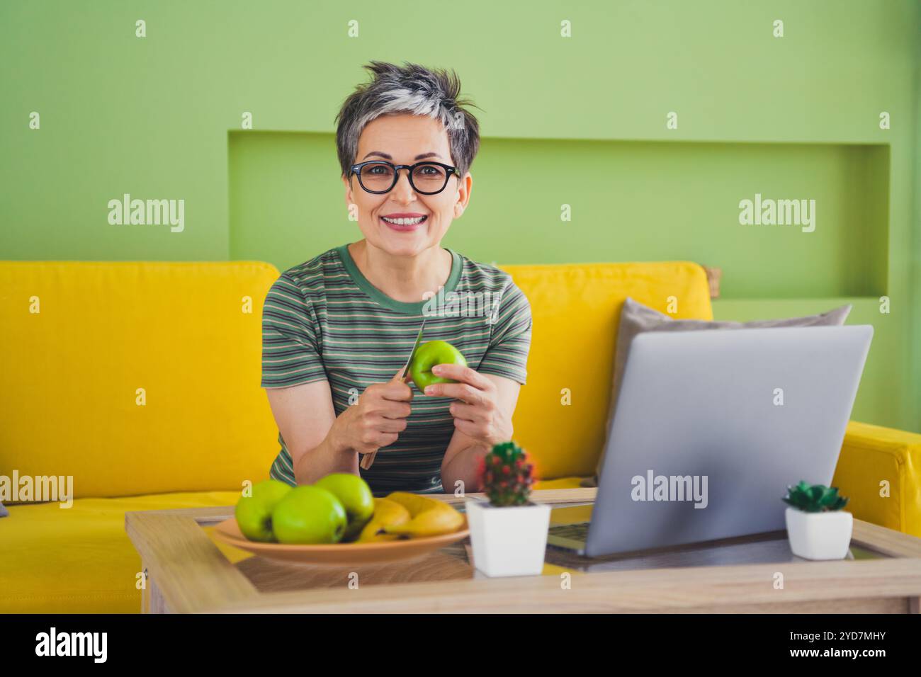 Photo of charming pensioner lady lunch eating apple dressed green ...
