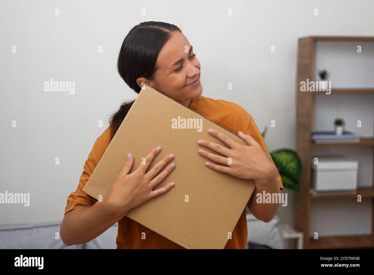 delighted woman clutches parcel, online shopping satisfaction as her ...