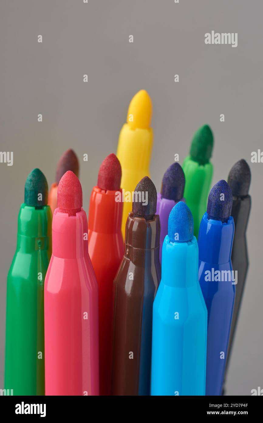 bunch of colorful felt tip or fiber tip pens uncapped isolated gray ...