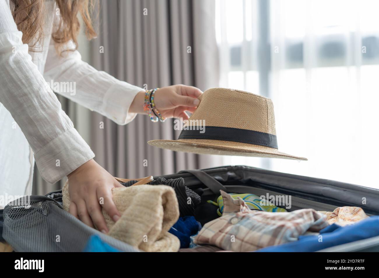 Woman packing suitcase on bed for a new journey packing list for travel ...