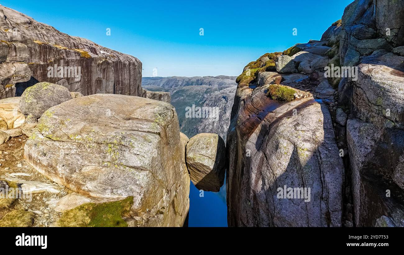 A scenic view of Kjeragbolten, Norway, a dramatic rock formation in ...