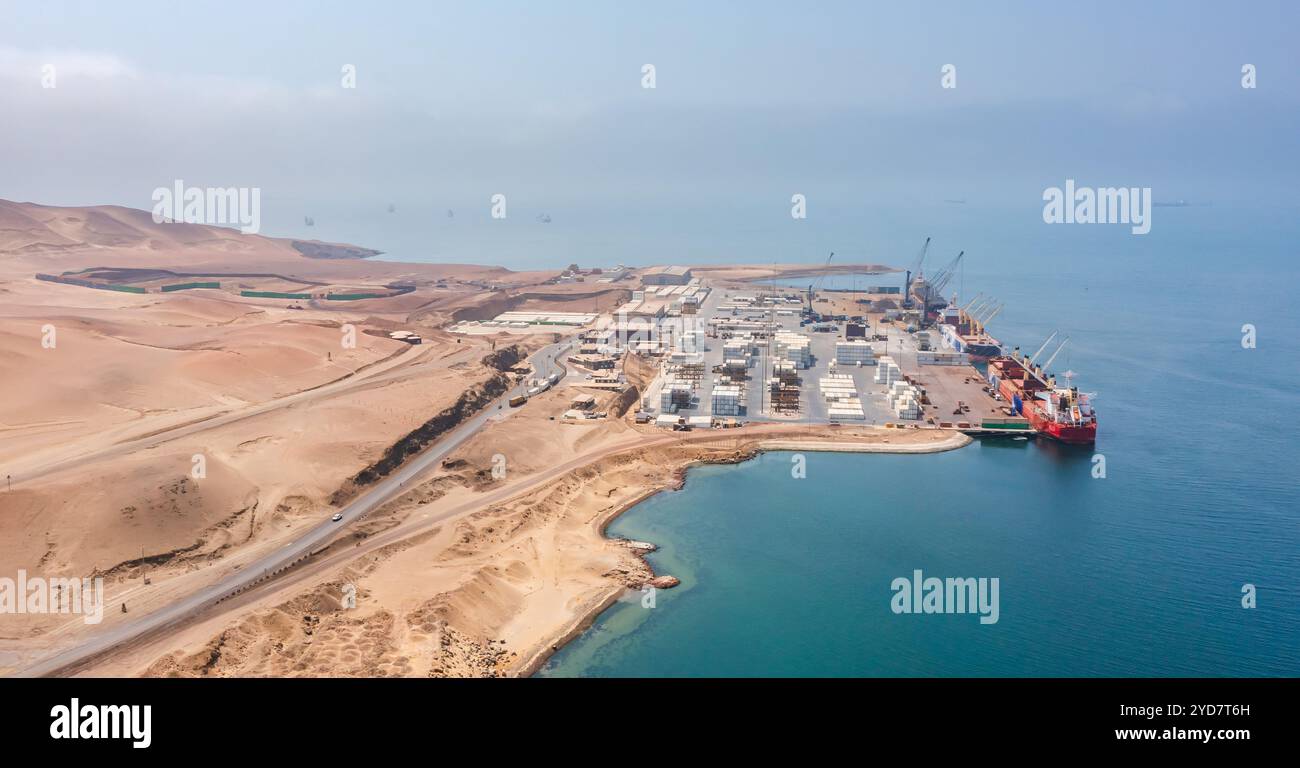 A red ship is docked at a port on a beautiful day Stock Photo - Alamy