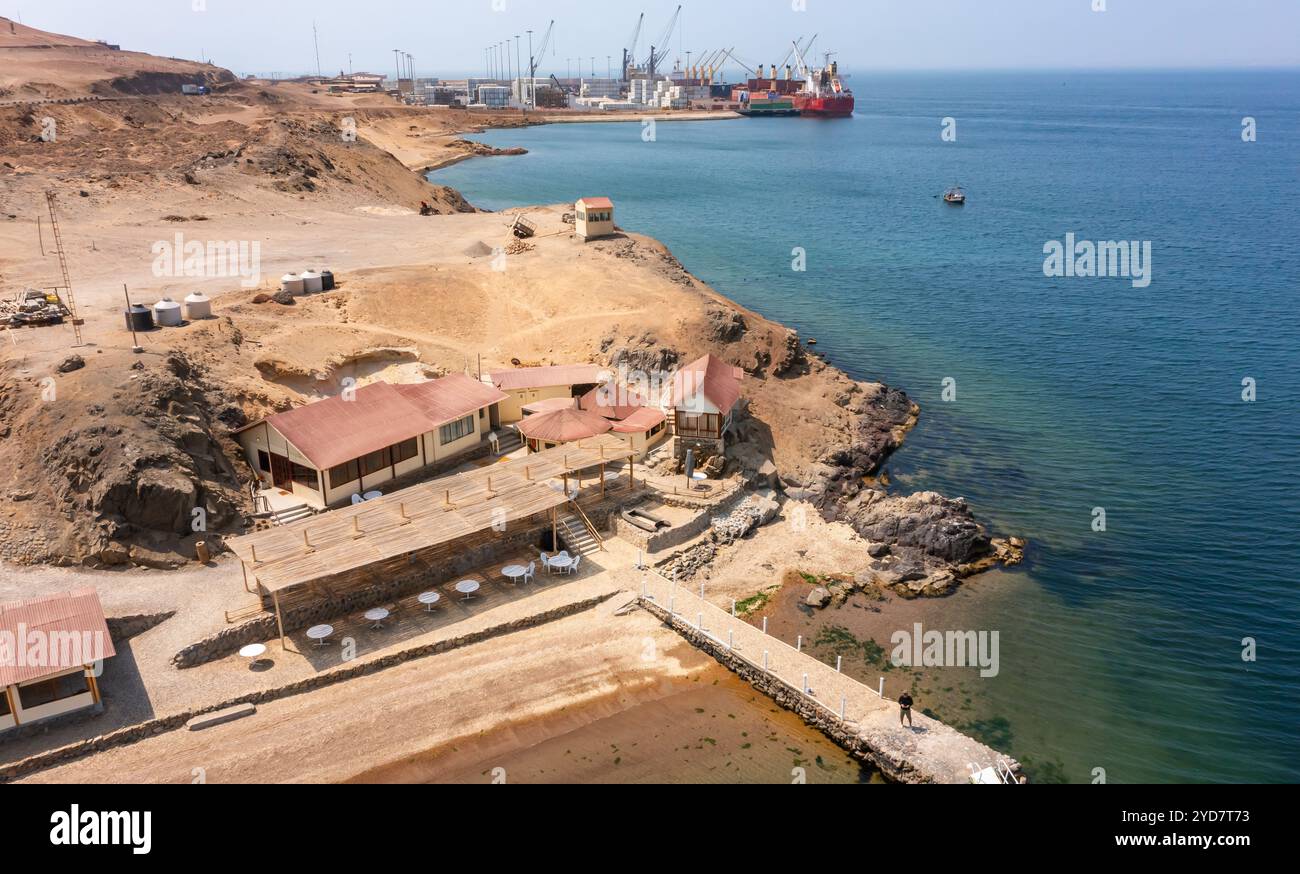 A beach with a small town on the shore, Paracas national park, Peru ...