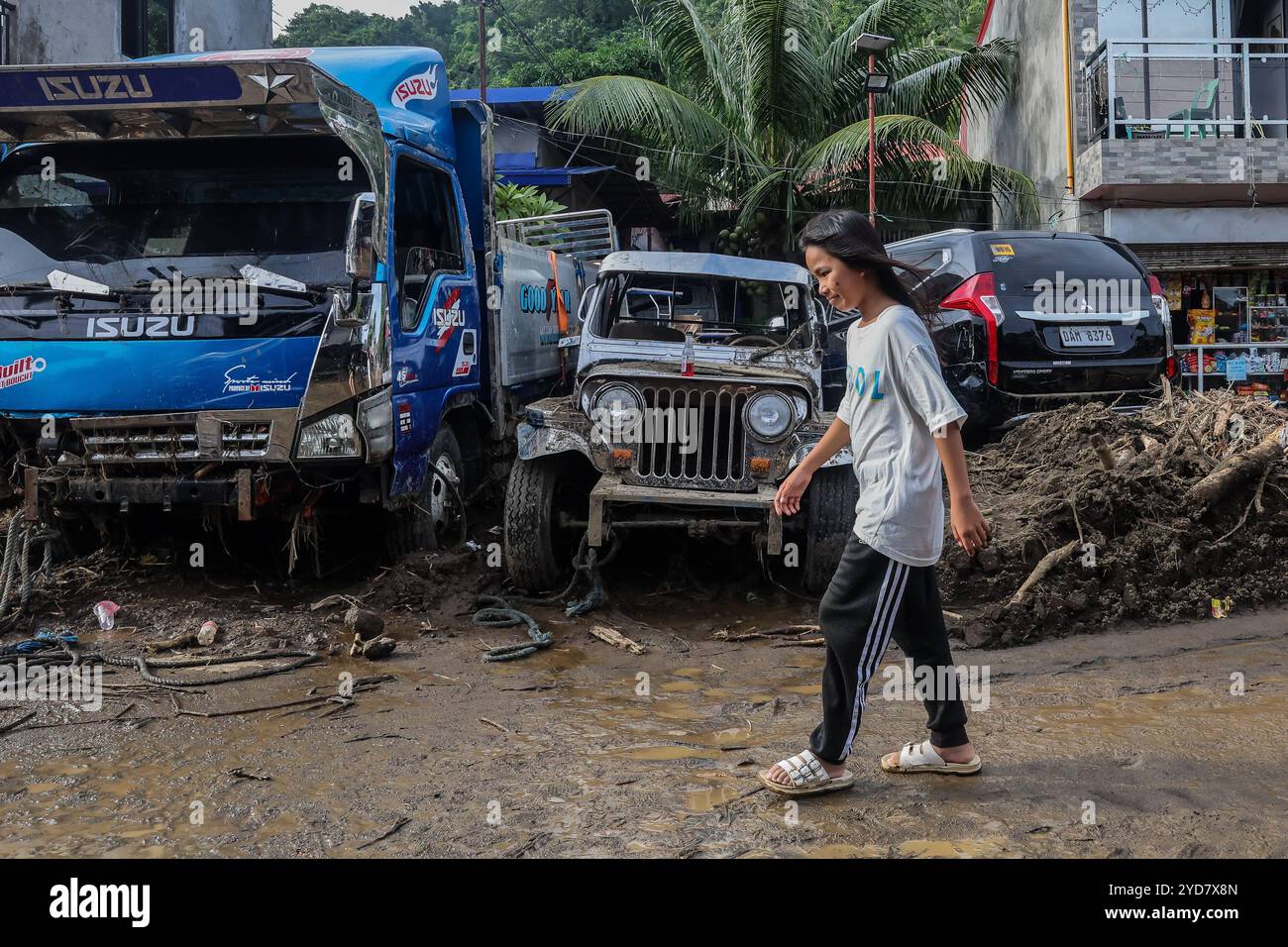 Batangas Province, Philippines. 25th Oct, 2024. A girl walks past ...