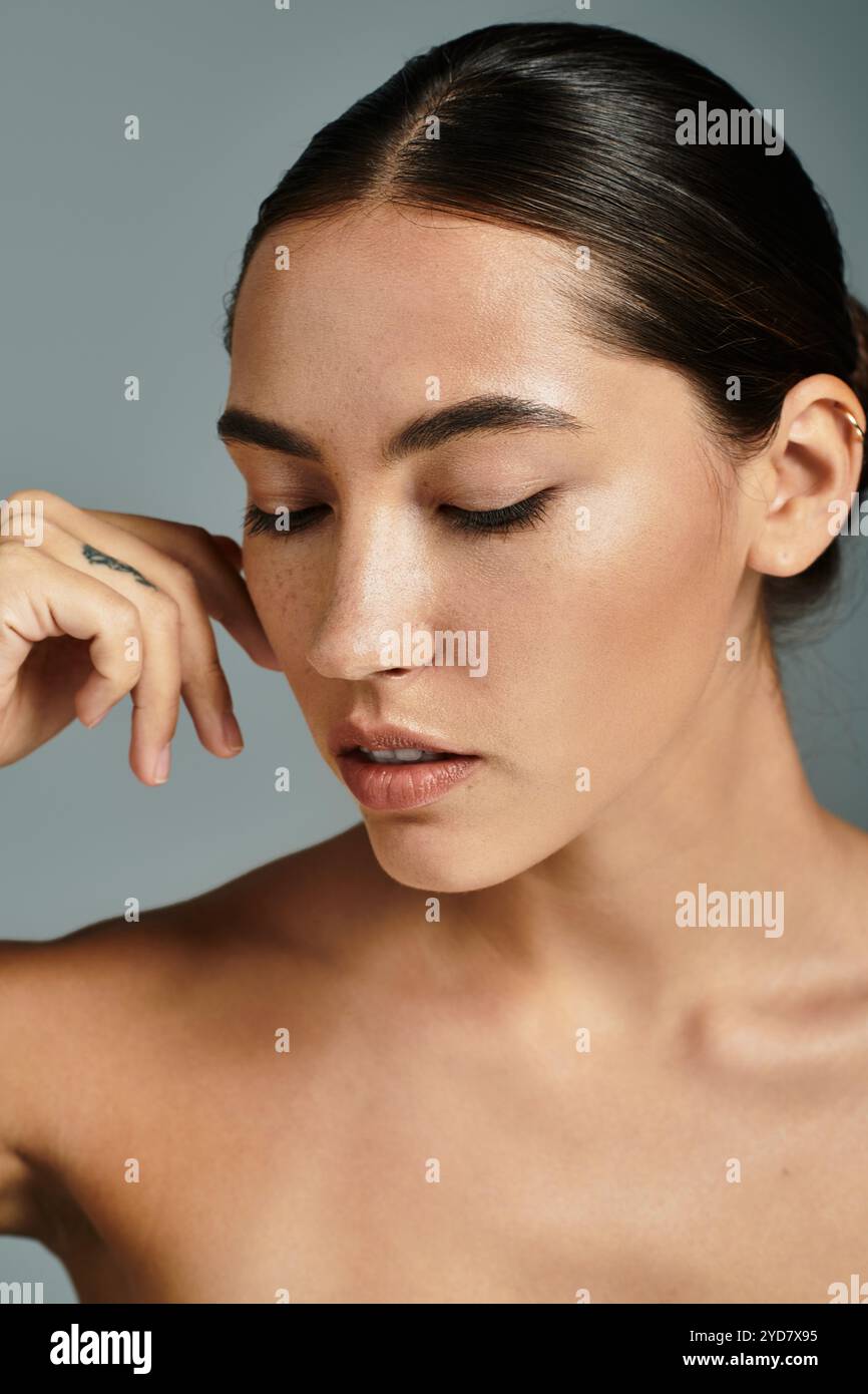 A woman embraces her elegance with a serene expression, illuminated ...