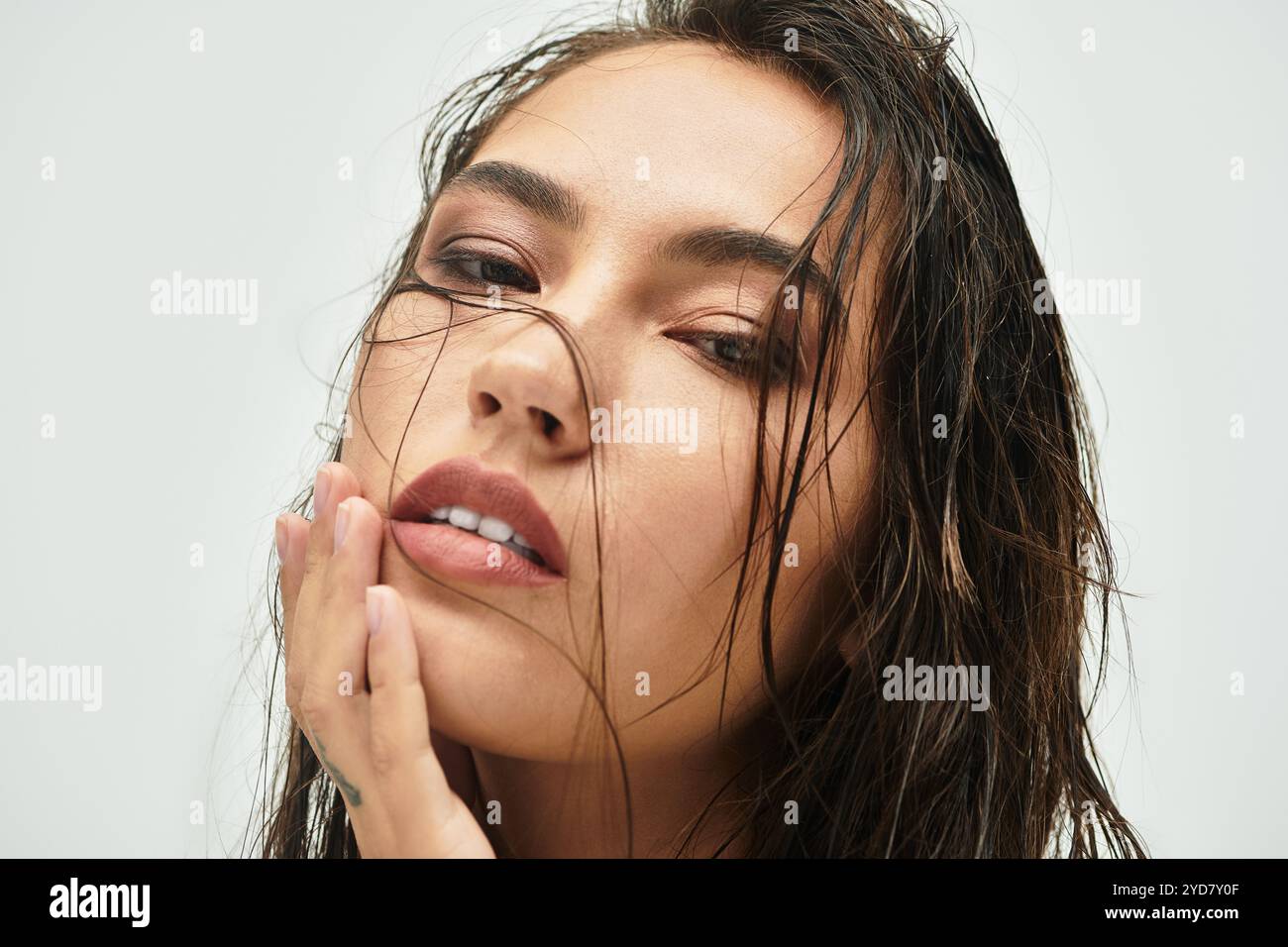Glimmers of light reflect off her wet hair as she embraces her natural ...