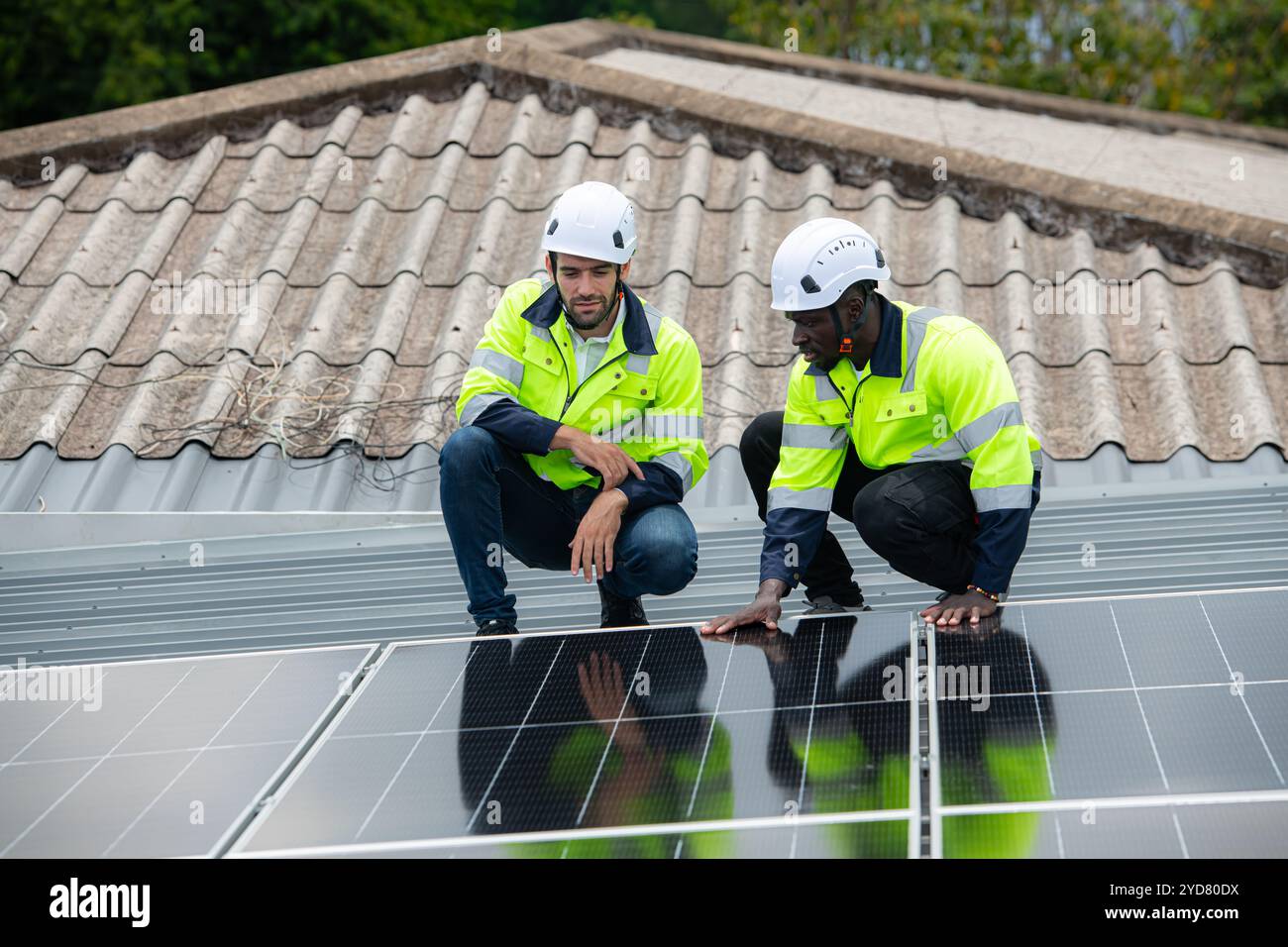 Engineer and technician inspects solar panel installation and test the ...