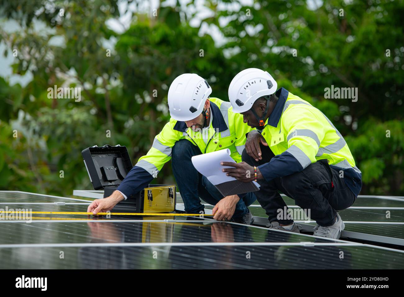 Engineer and technician inspects solar panel installation and test the ...