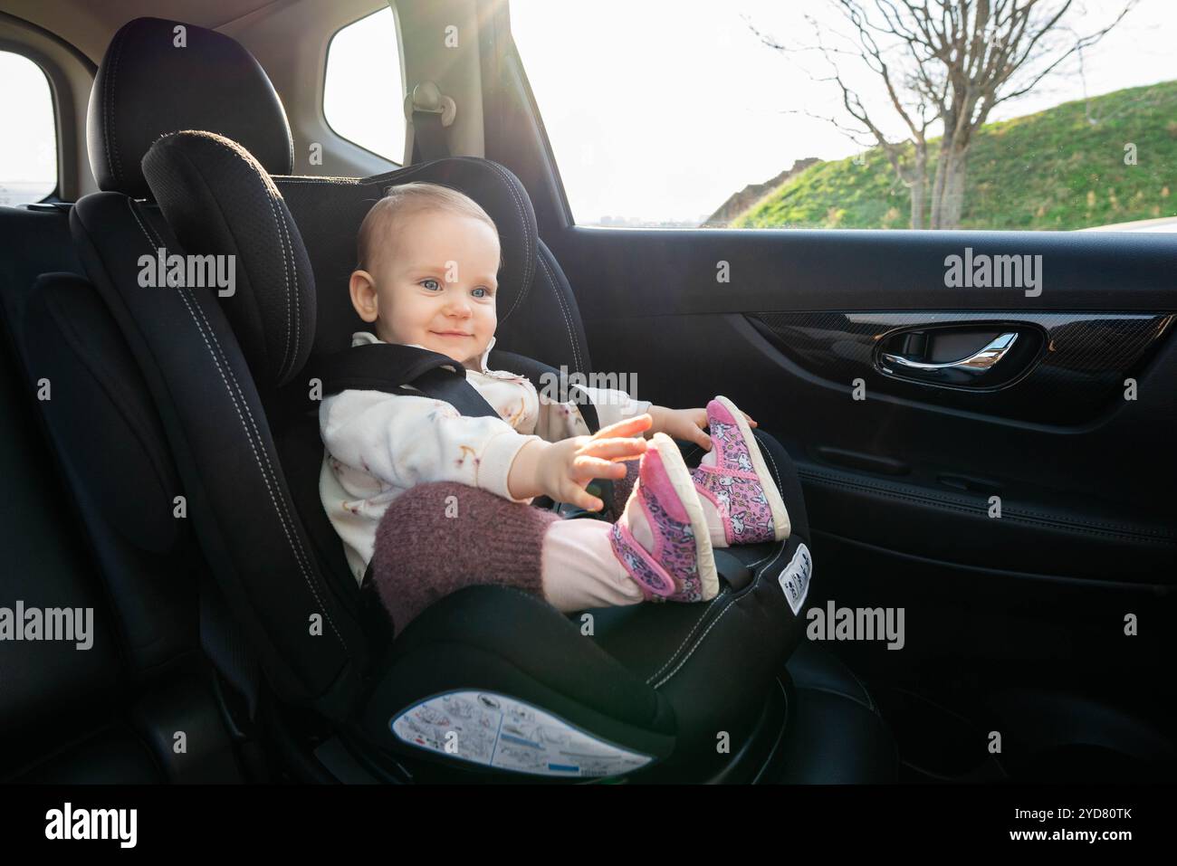 Joyful, smiling baby in a car seat enjoying a car ride Stock Photo - Alamy