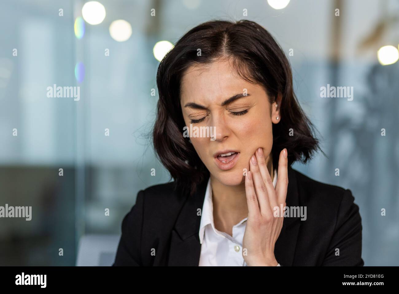 Businesswoman feeling toothache at work, expressing pain and discomfort ...