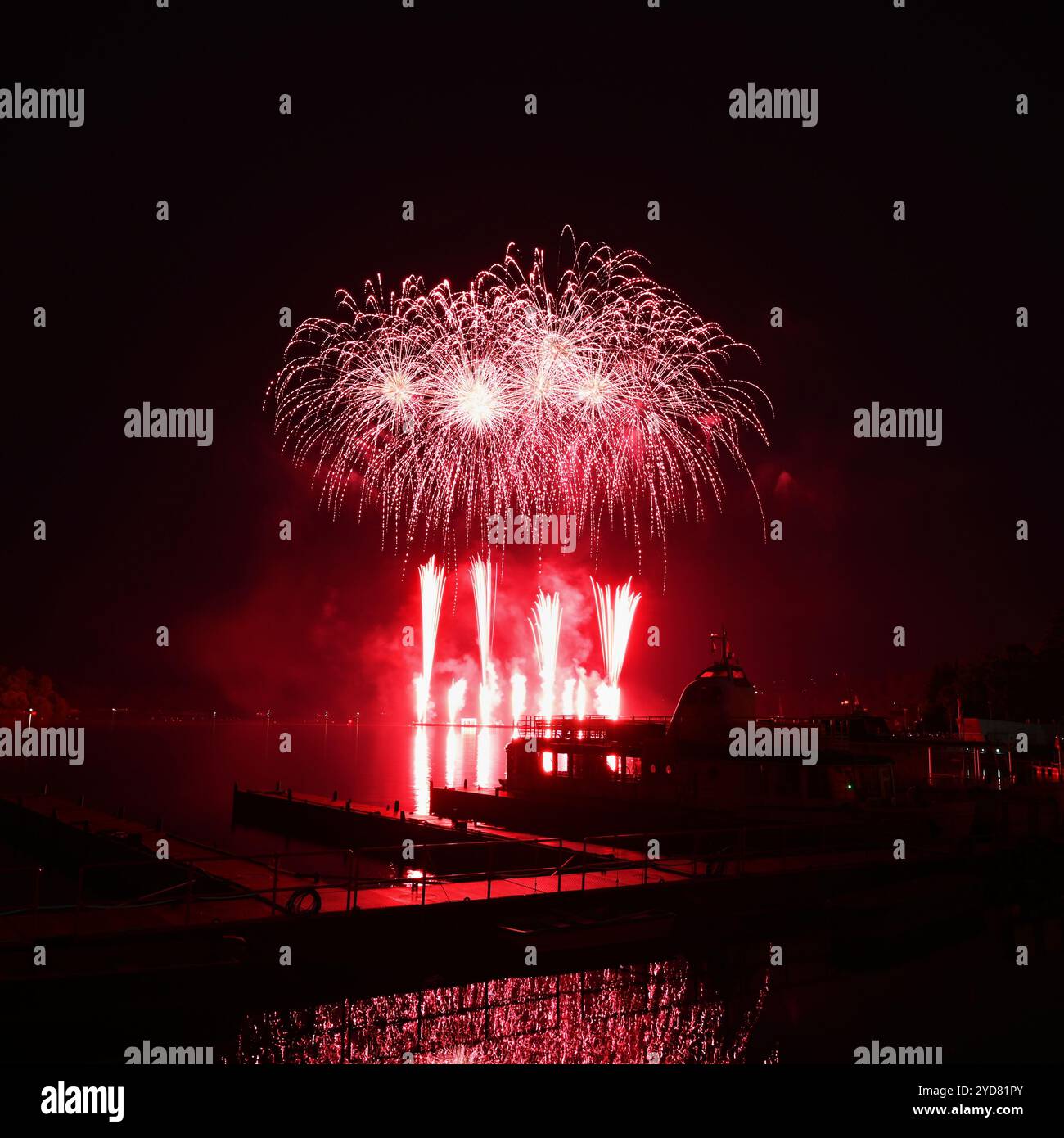 Firework. Beautiful colorful fireworks on the water surface with a ...