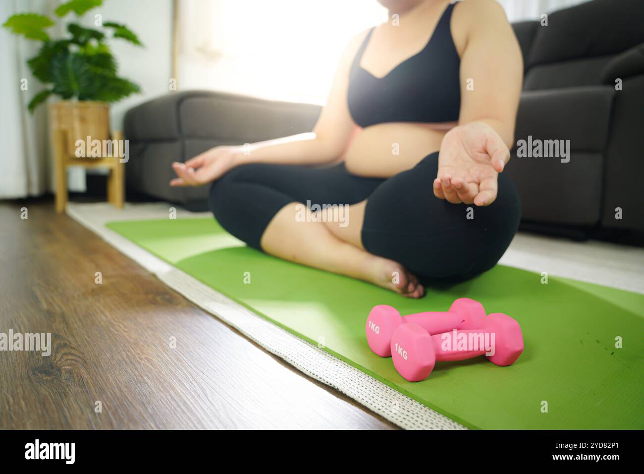 Overweight woman exercising for weight loss. exercise with dumbbells in ...