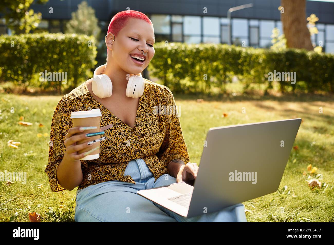 A beautiful bald woman smiles brightly as she sips coffee and engages ...