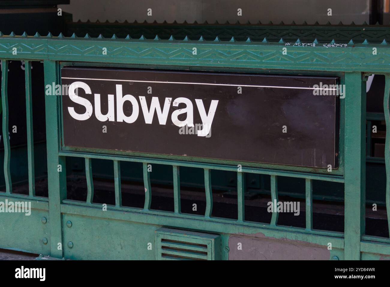A signage is positioned at the entrance of the urban subway in the ...