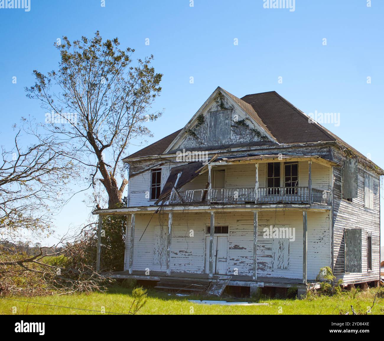 White abandoned two story farm house in southern Georgia USA, damaged ...