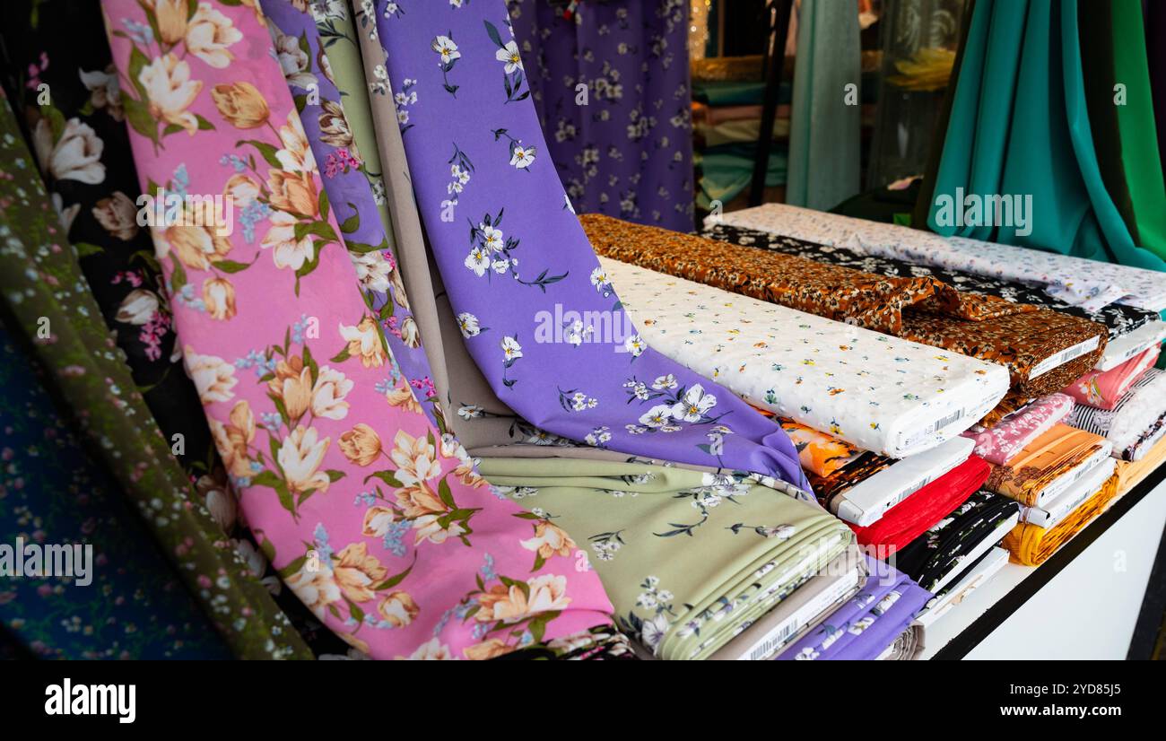 Fabrics and bolts of fabric in various colors and patterns. Fabrics and ...