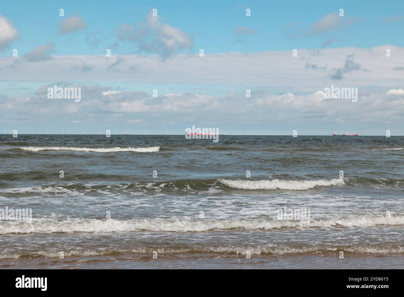 Waves at the beach, transport ships and offshore wind farm in the ...