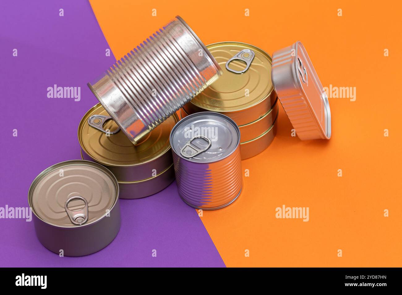 A Group of Stacked Tin Cans with Blank Edges on Split Orange and Violet ...