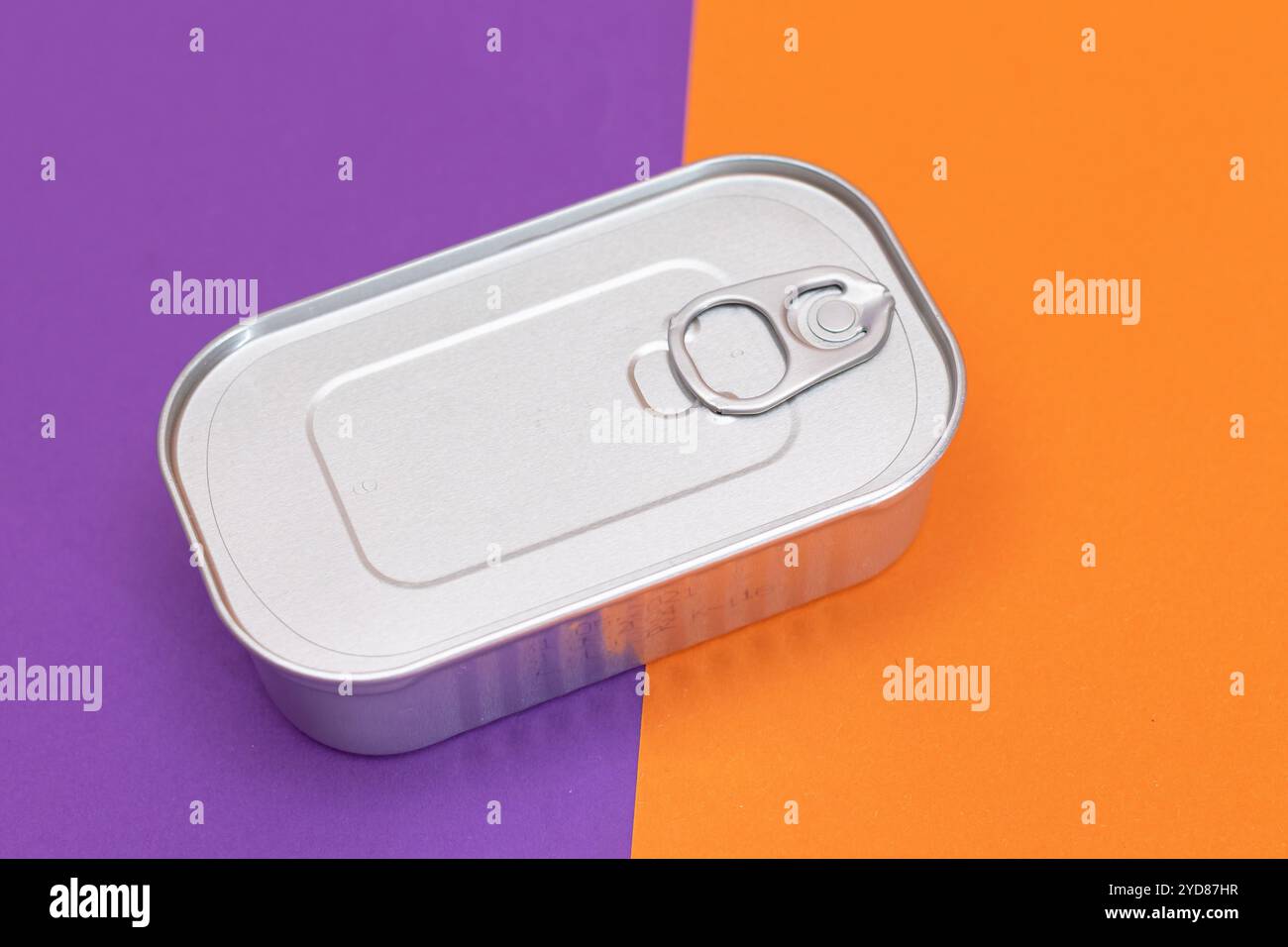 Unopened Tin Can on Split Orange and Violet Background. Canned Food ...