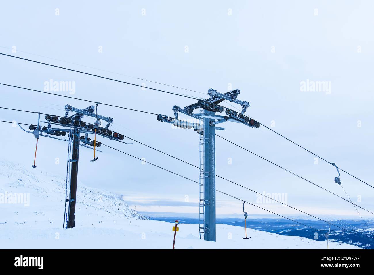Ski lift at a ski resort against the backdrop of snowy mountains ...