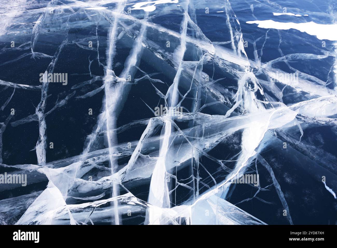 View of the beautiful transparent blue ice with cracks of frozen Baikal ...