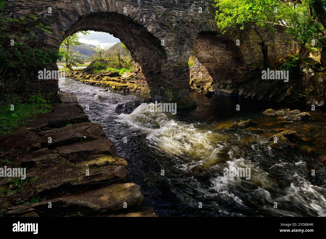 stone bridge,stone arches,stone arched bridge,rushing water at the ...
