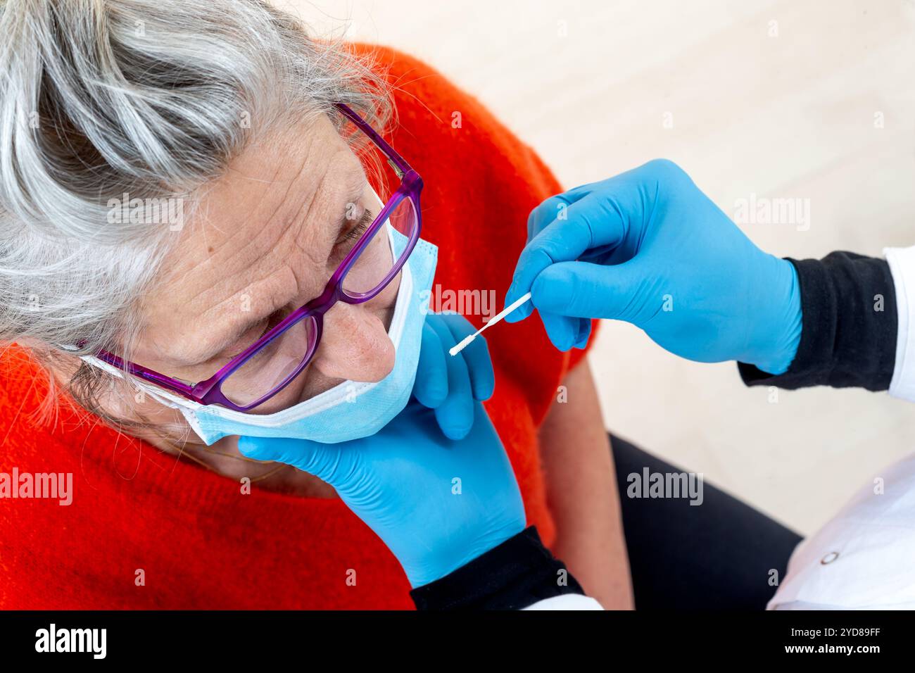 Elderly woman undergoing nasal screening test Stock Photo - Alamy