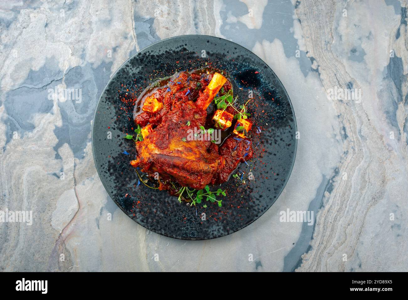 Traditional braised slow cooked lamb knuckle with eggplant and Greek ...