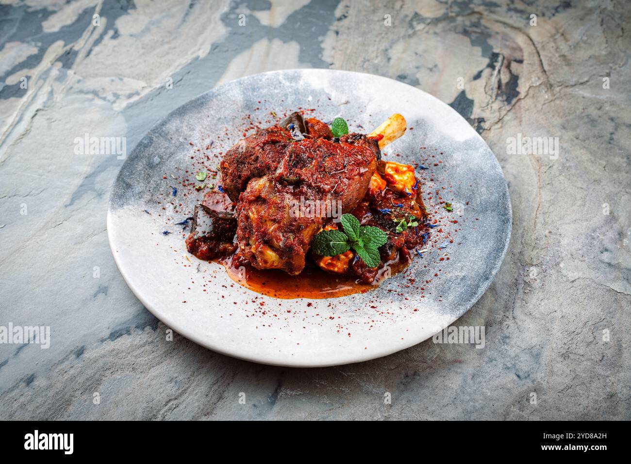 Traditional braised slow cooked lamb knuckle with eggplant and Greek ...