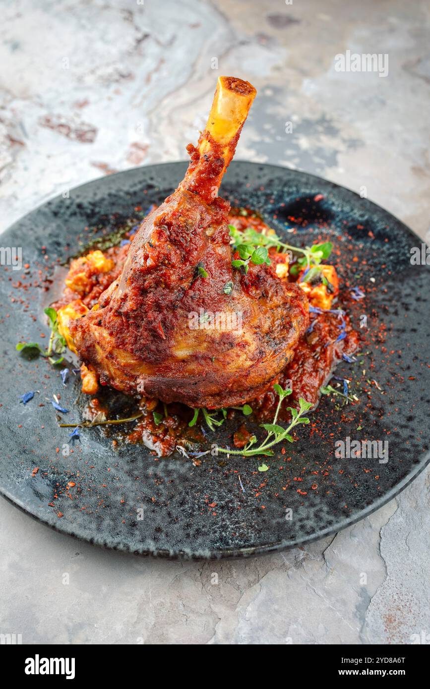 Traditional braised slow cooked lamb knuckle with eggplant and Greek ...