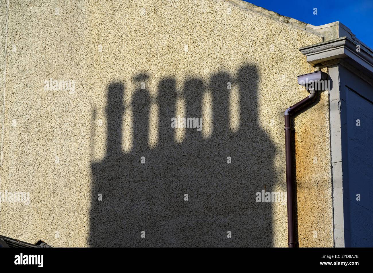 Shadow of a home chimney stack falling on to a gable in the morning ...