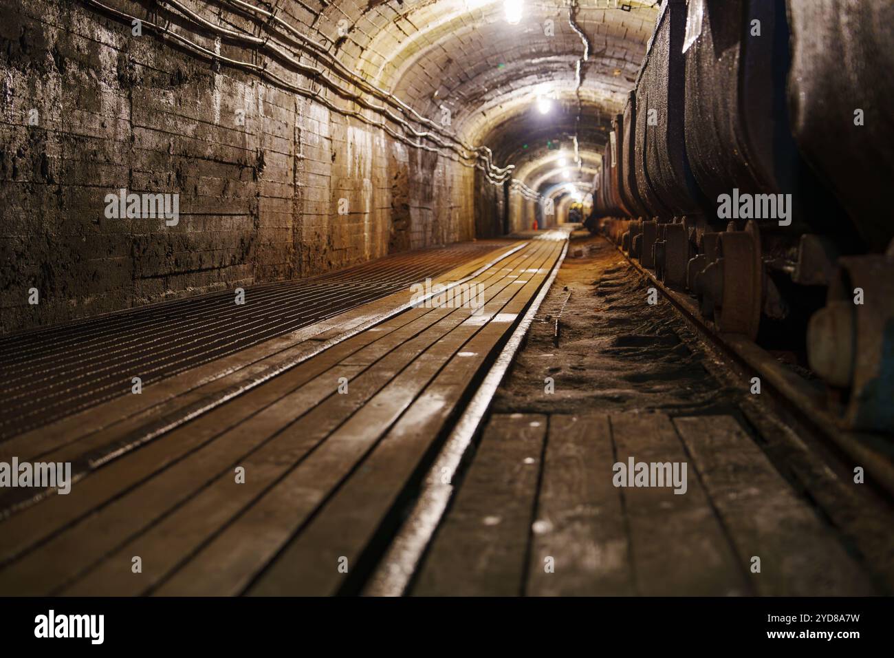 A Captivating View of an Old Rusty Mine Tunnel with Tracks and Vintage Mining Carts Inside Stock ...