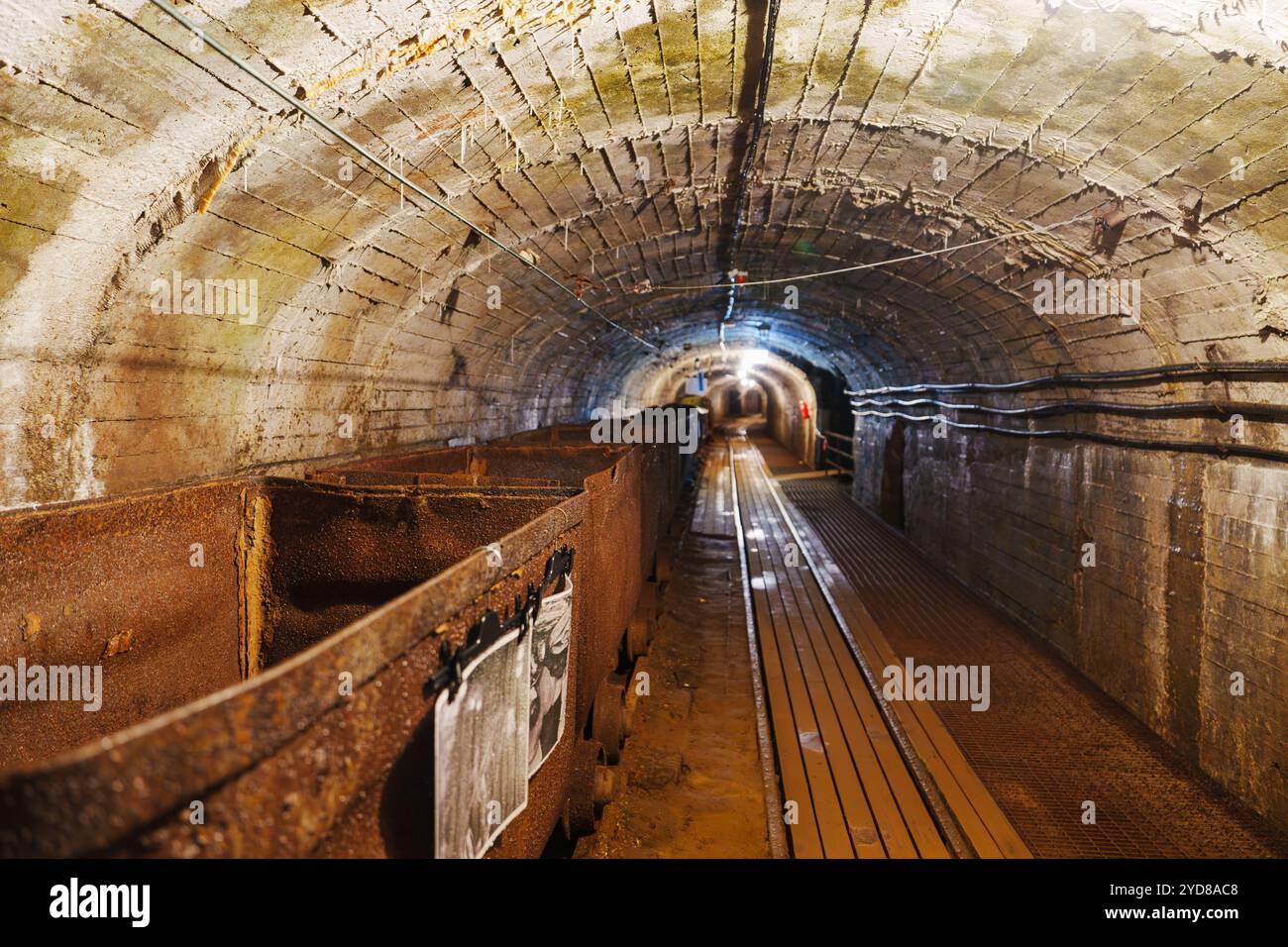 A Vintage Mining Cart on Rusty Tracks in a Dark, Eerie Mine Tunnel ...