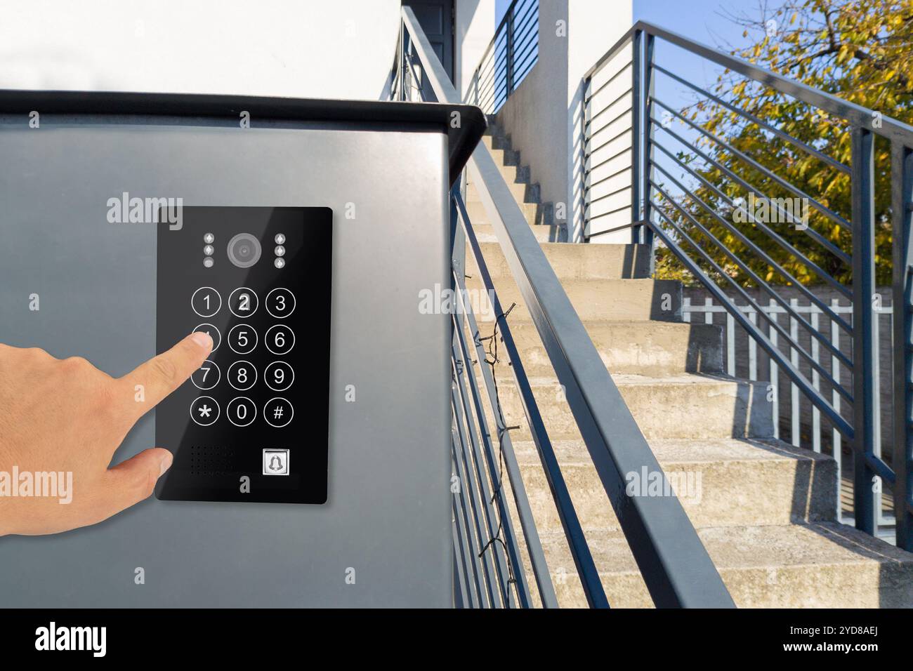 Hand using keypad on modern security system by stairs Stock Photo - Alamy