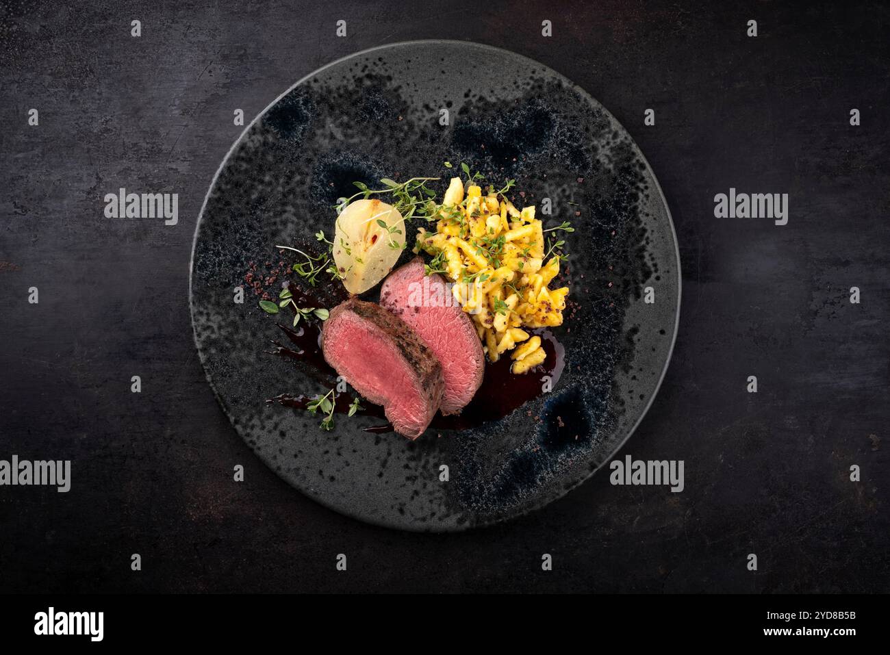 Traditional fried venison back filet with sliced pear Stock Photo - Alamy