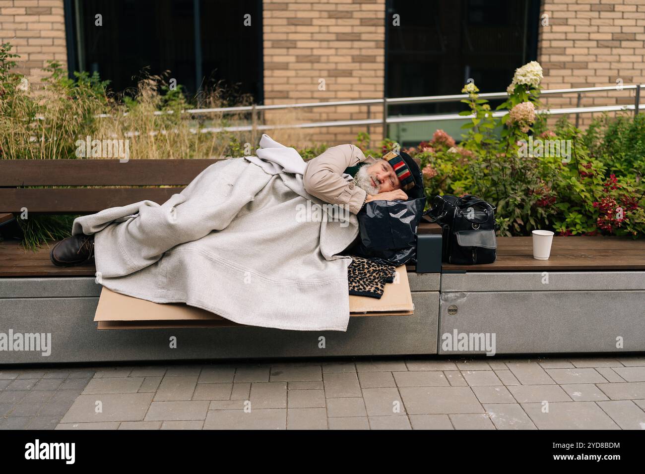 Lone homeless mature male resting on city bench, symbolizing hardships ...
