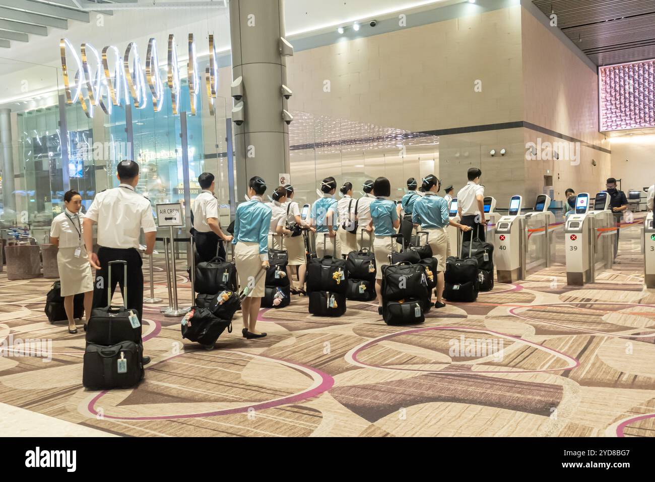 Korean Air cabin crew with luggage at the entrance to Singapore Changi ...