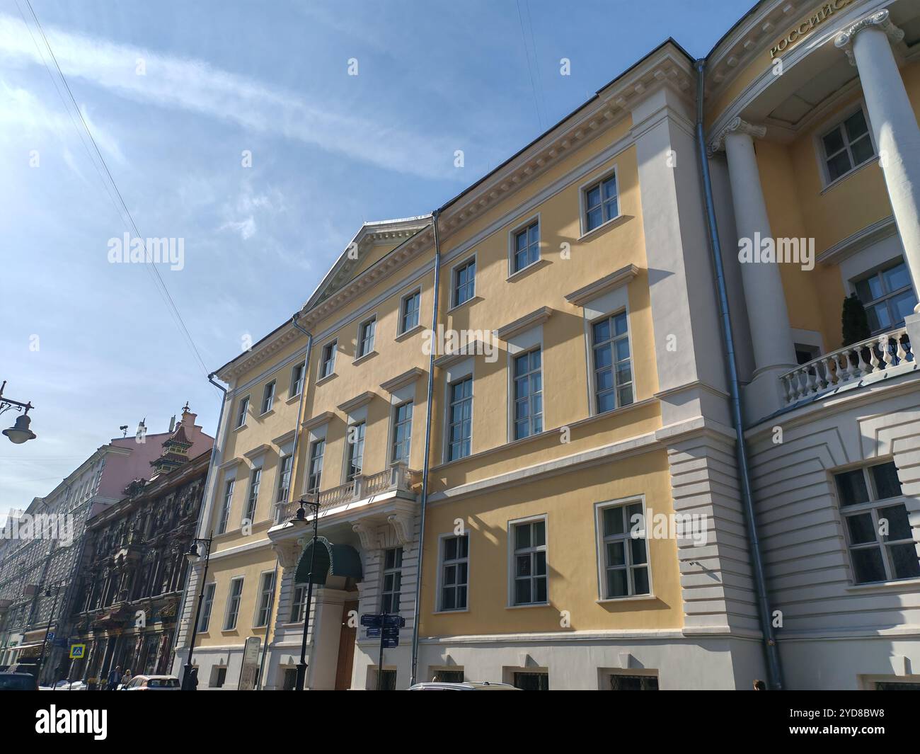 grand yellow building with symmetrical windows and classical detailing ...