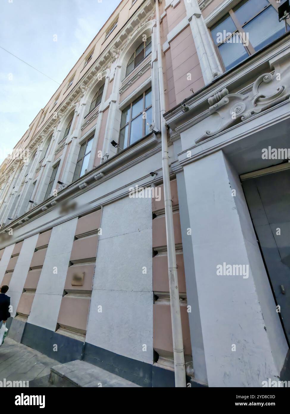 large residential building with a pink facade, decorated with classical ...