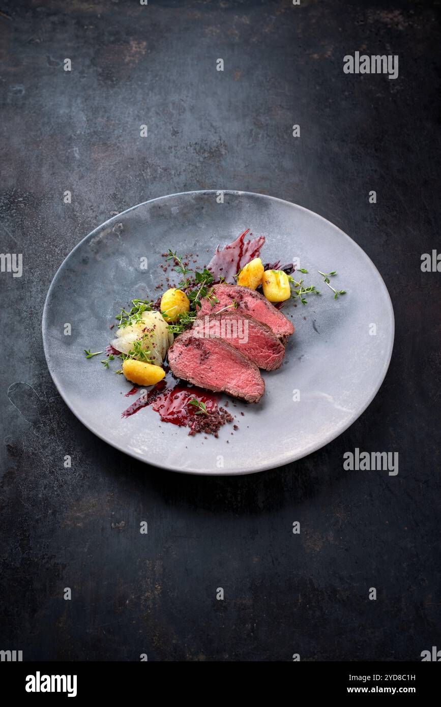 Traditional fried venison back filet with sliced pear Stock Photo - Alamy