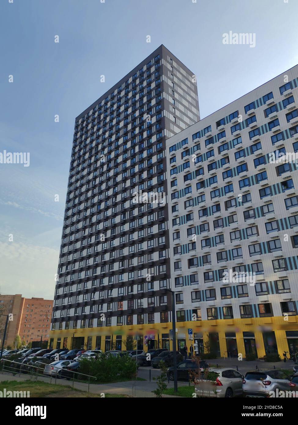 Two high-rise buildings featuring a dynamic contrast of yellow and ...