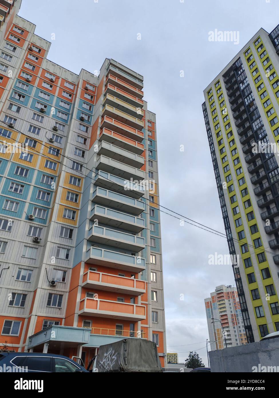 A towering residential building with pastel accents, featuring a wide ...