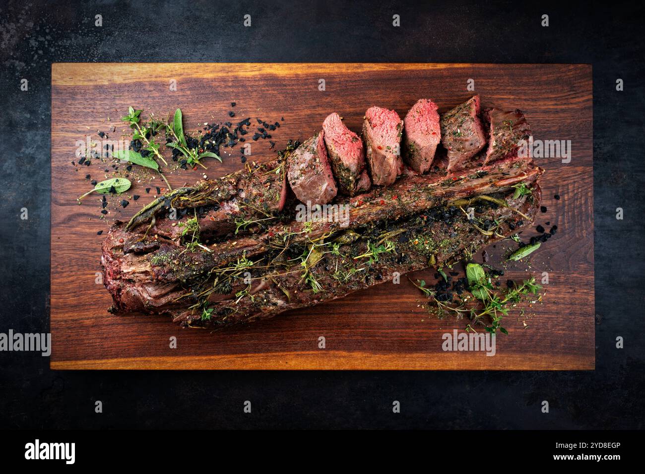 Traditionally roasted saddle of venison with fillet pieces and herbs ...