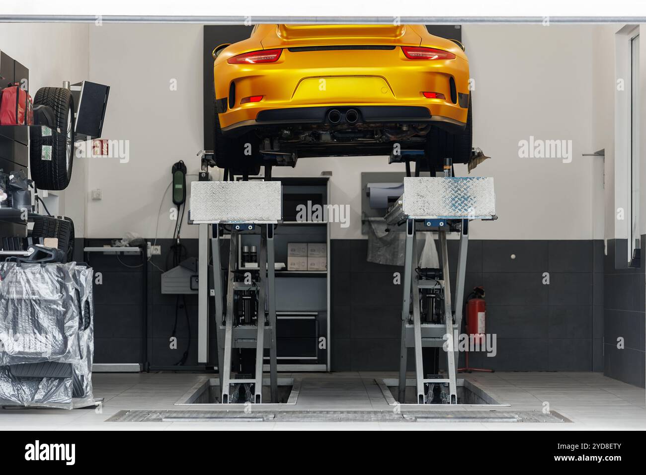 Sport luxury car raised on hydraulic lift perform diagnostics ...