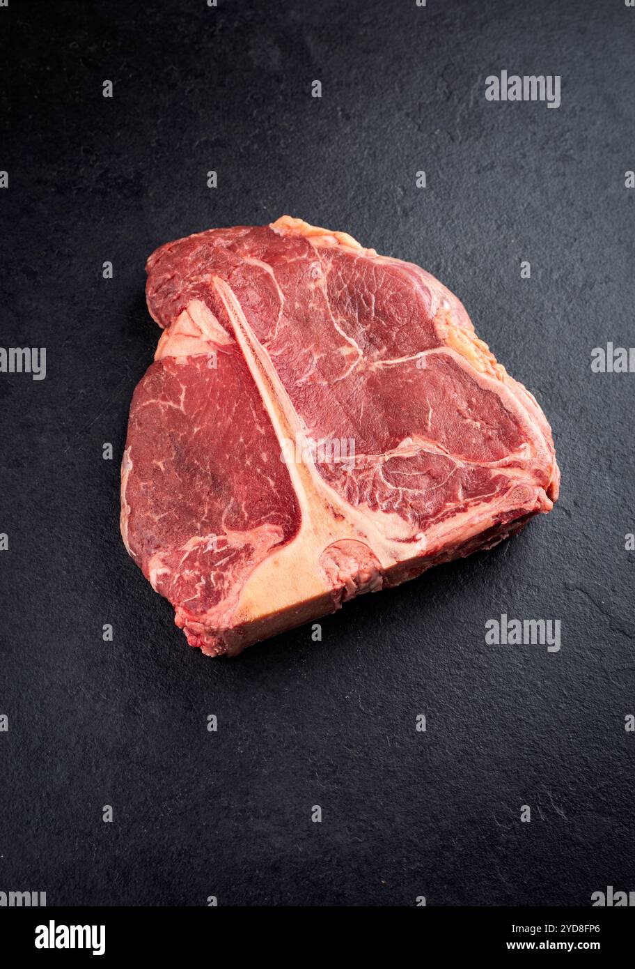 Raw dry aged chianina porterhouse beef steak offered as close-up on ...