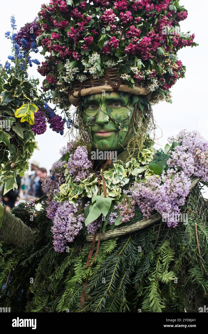 Green Man in vibrant floral costume, adorned with colorful flowers ...