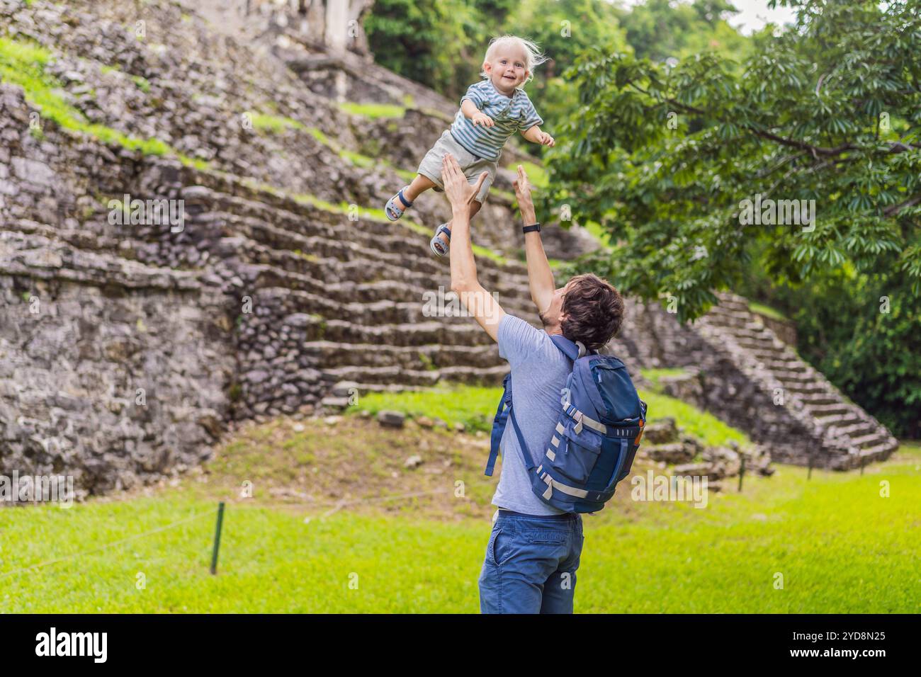 Father with his toddler son exploring the ancient pyramids of Palenque ...