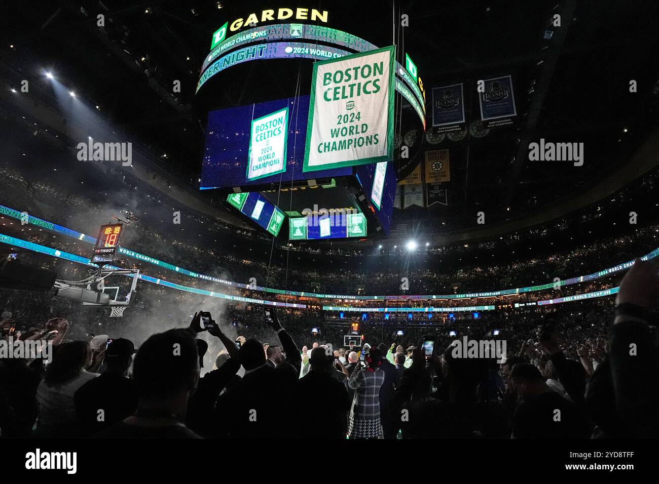 The 2024 NBA Championship banner rises during a banner raising ceremony ...