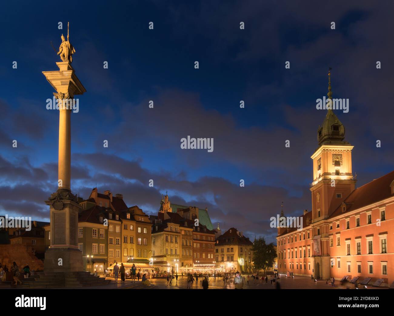 The charming old town of Warsaw glows softly as dusk settles ...